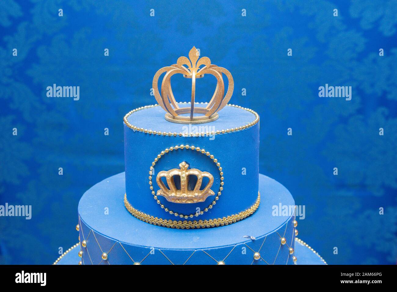 Fake blue birthday cake with a crown on top Stock Photo - Alamy
