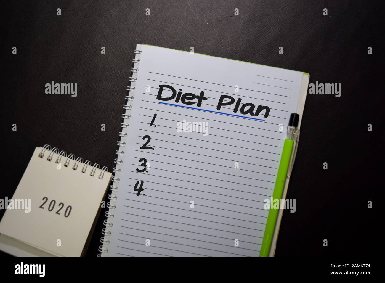Diet Plan write on a book isolated on black table Stock Photo - Alamy