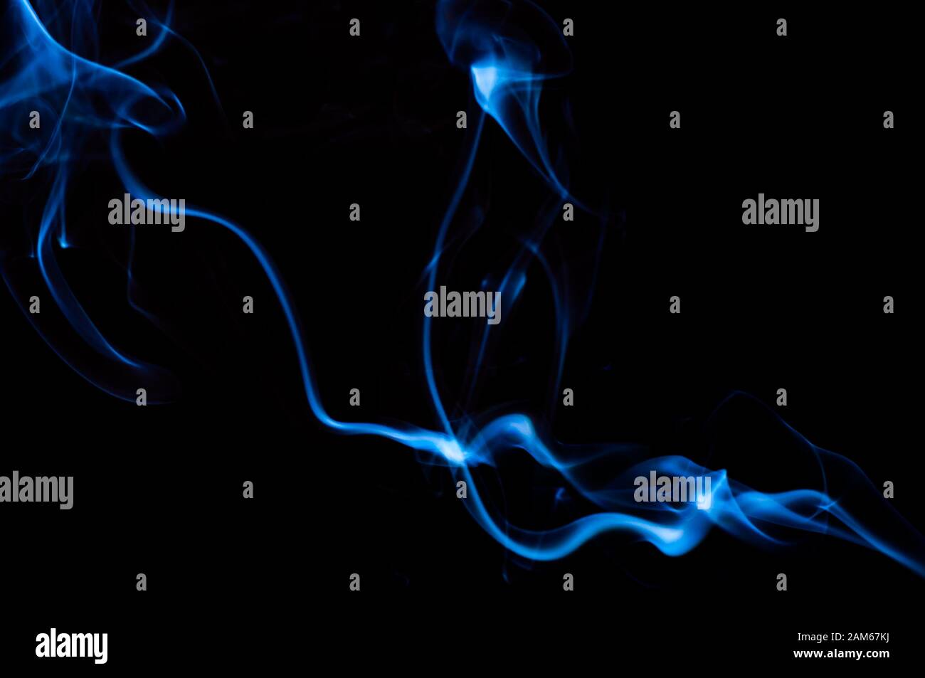 Puffs of blue smoke on a black background Stock Photo - Alamy
