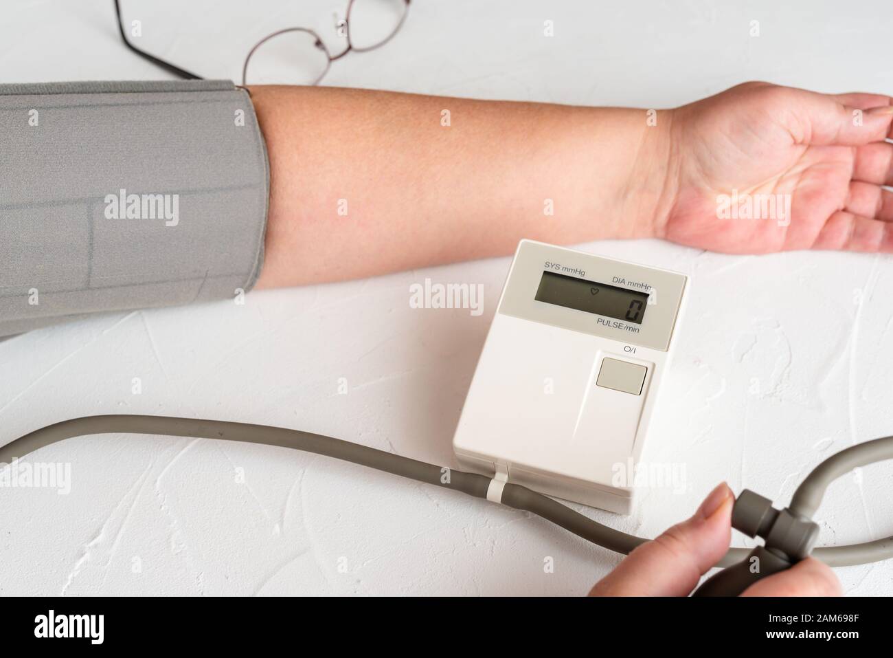 Checking blood pressure with measuring device. Healthcare and medical ...