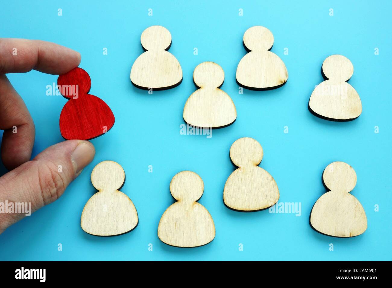 Hand holds red figure as symbol of uniqueness. Unique stand out of the ...