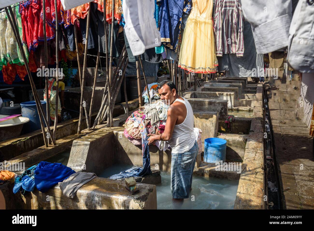 Indian woker washing clothes in Dhobi Ghat is outdoor laundry in Mumbai ...