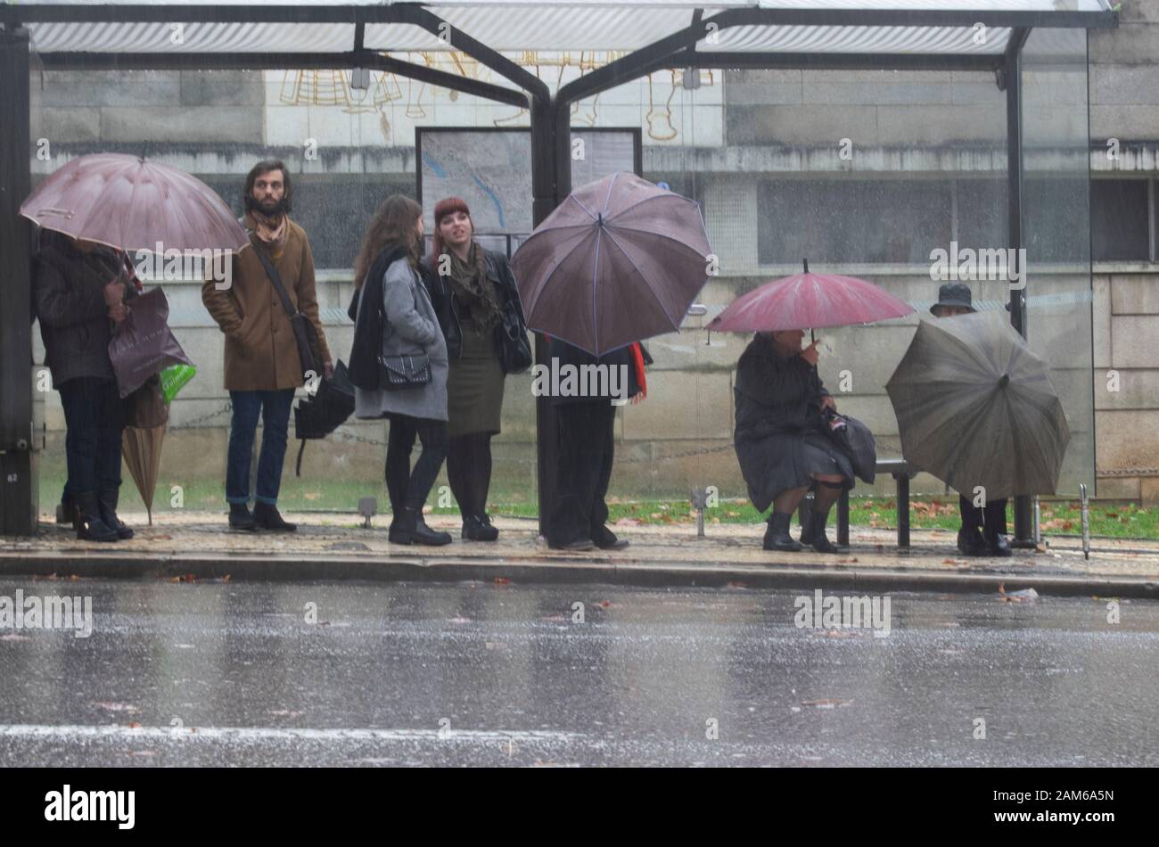 Waiting for bus in the rain hi-res stock photography and images - Alamy