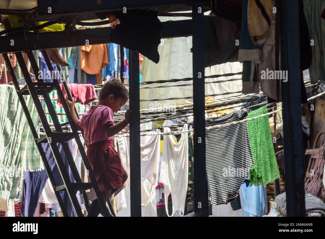 Indian young boy in Dhobi Ghat is outdoor laundry in Mumbai. India ...
