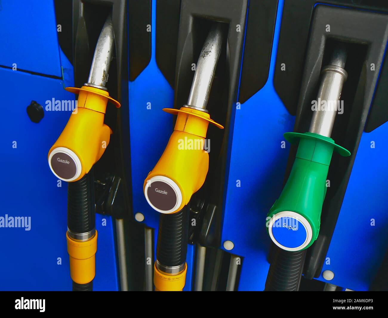 Three diesel and super unleaded 95 pumps, yellow and green, at a ...