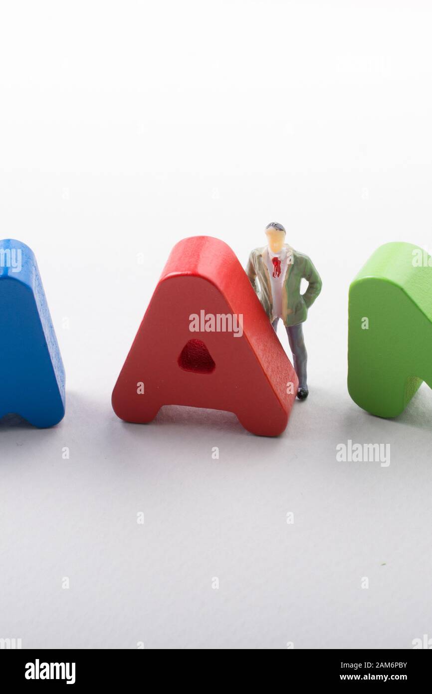 Tiny figurine of men beside colorful wooden letters say MAN Stock Photo ...
