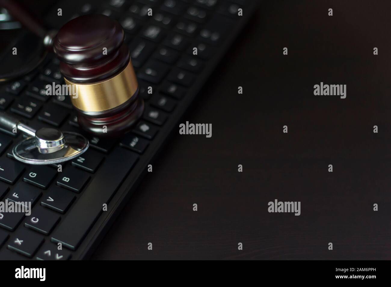 Judge's gavel and medical stethoscope on computer keyboard with copy ...