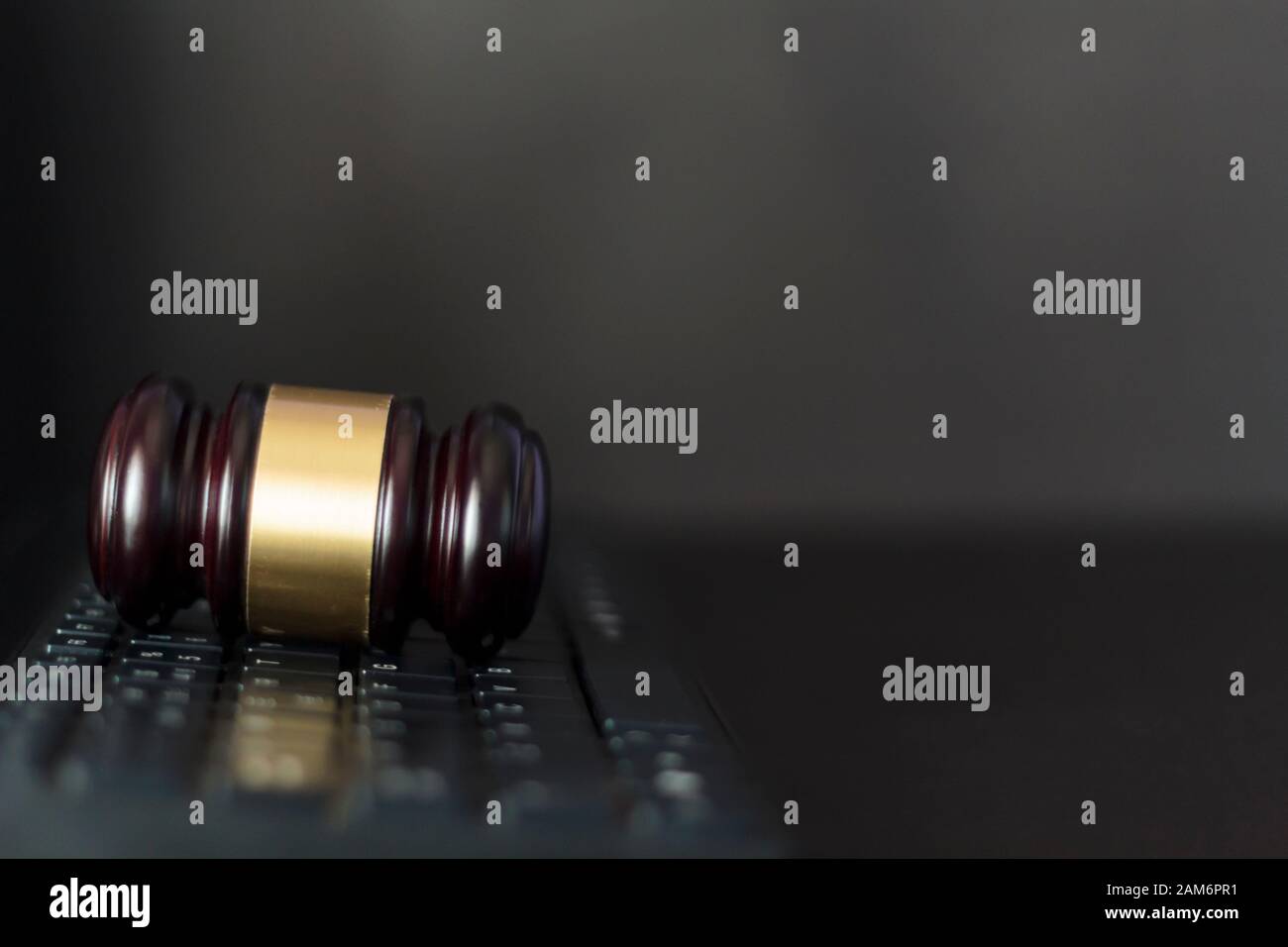 Judge's gavel on computer keyboard on black background with copy space ...