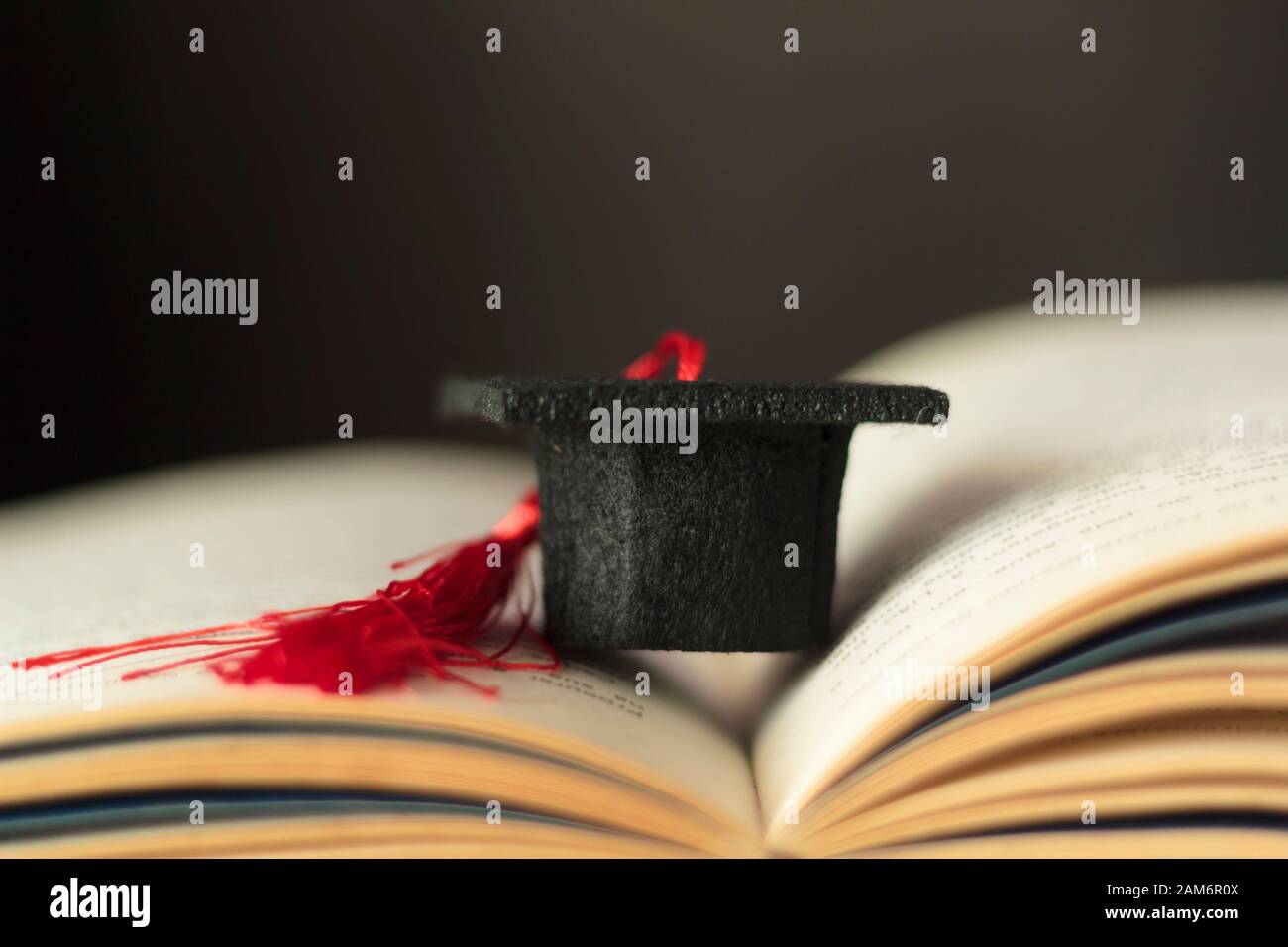 Graduation cap on top of open book. Education and Graduation concept ...