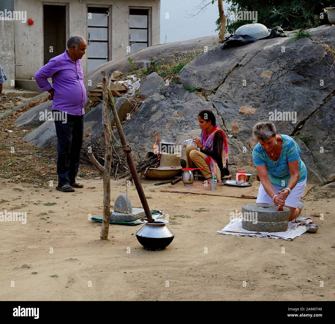 Vanaashrya, India - 12th November 2019:Local lady by the open fire as a ...