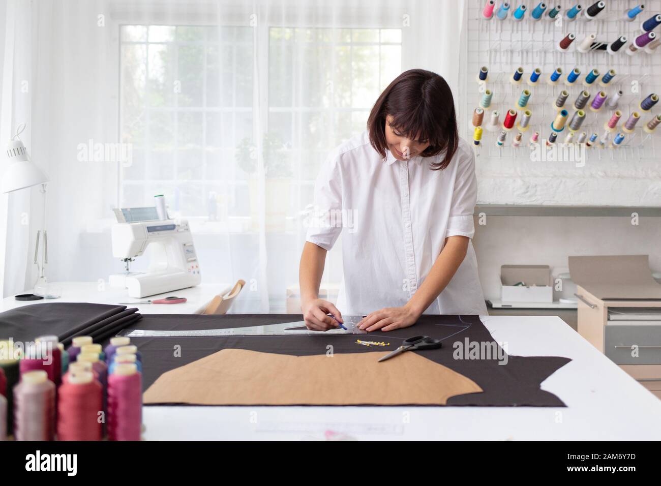 Close up portrait of fashion designer working in sewing studio Stock ...