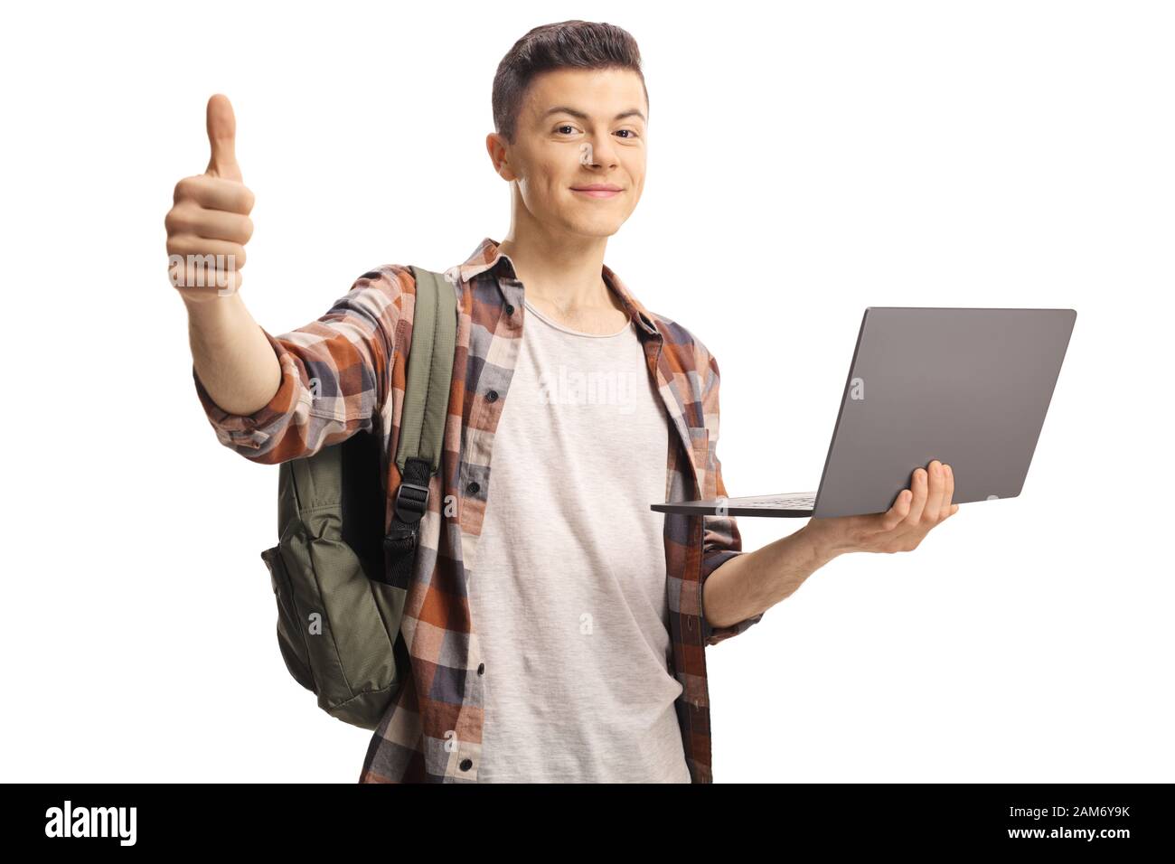 Male student gesturing a thumb up and holding a laptop computer ...