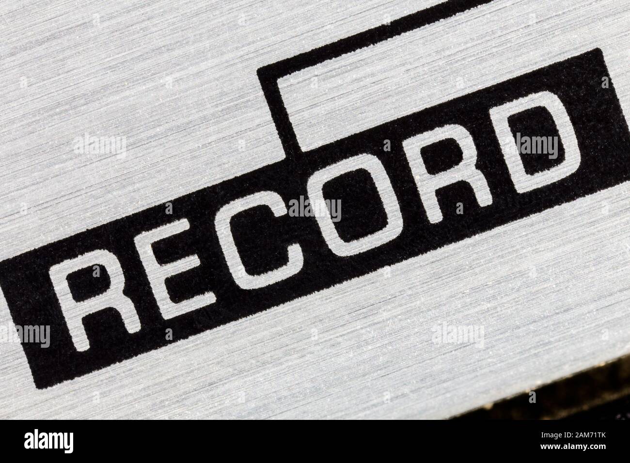 Macro close up photograph of old tape machine record button function ...