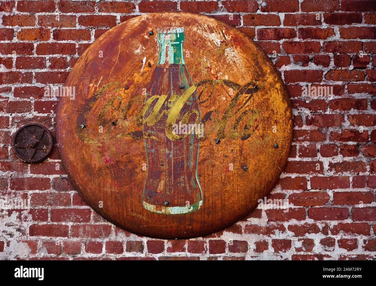 Faded rusty Coca Cola sign on red brick wall Stock Photo - Alamy