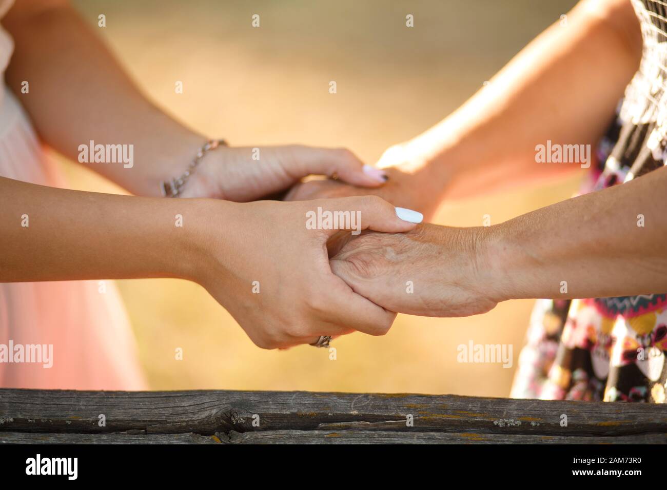 Closeup people hold hands of each other Stock Photo - Alamy
