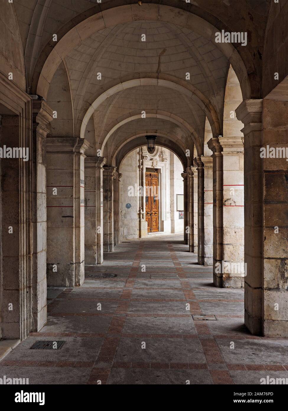 domed stone archways above square pillars of paved precinct walkway ...