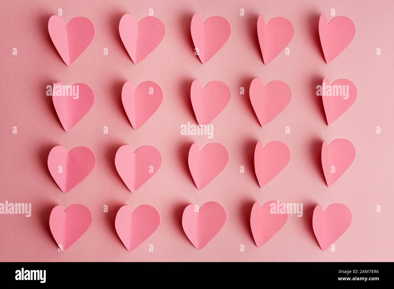 Pink paper hearts on pink background. Paper hearts arranged in rows on ...