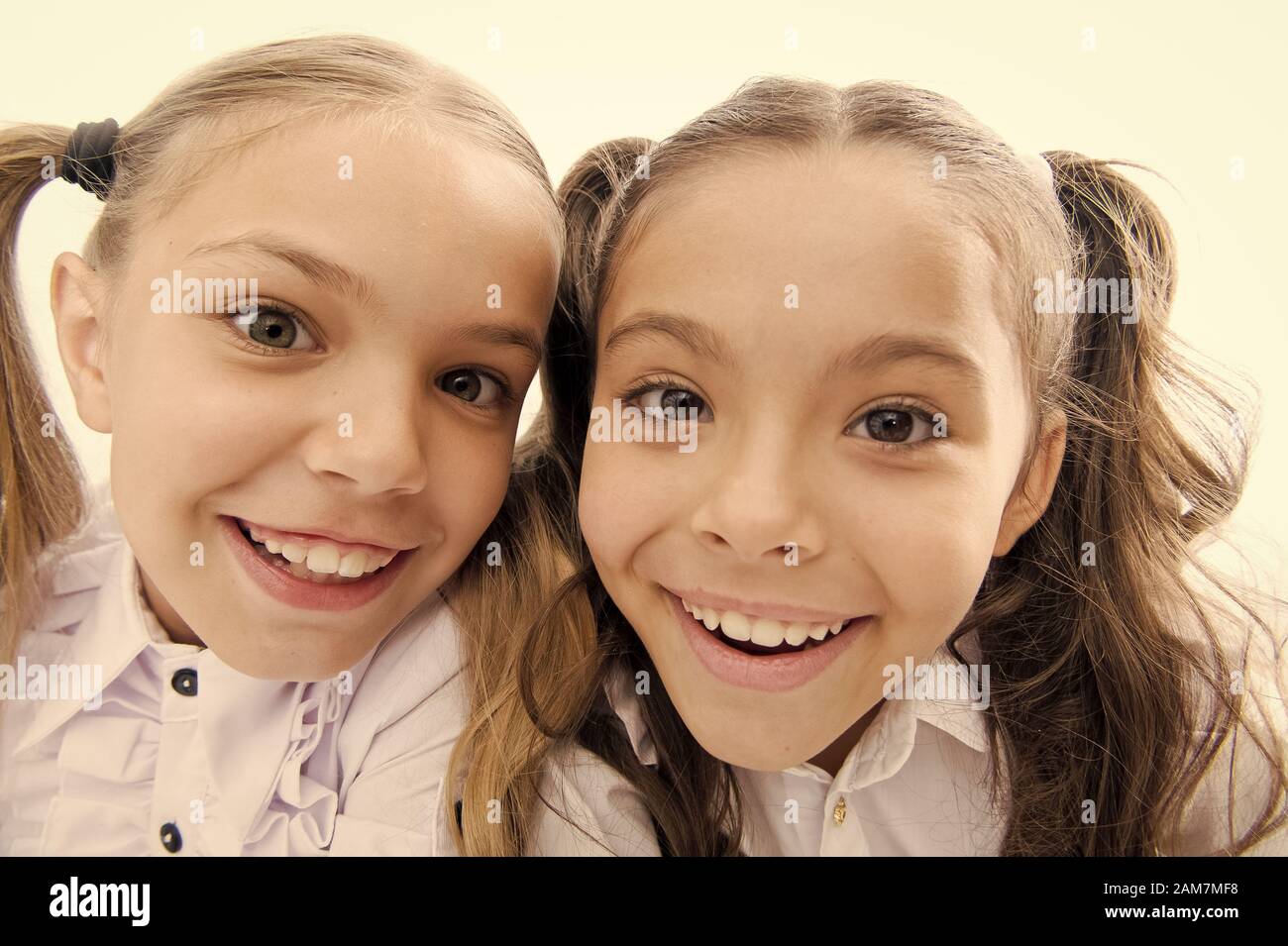 A whole new look. Happy school girls. Adorable little girls smiling ...