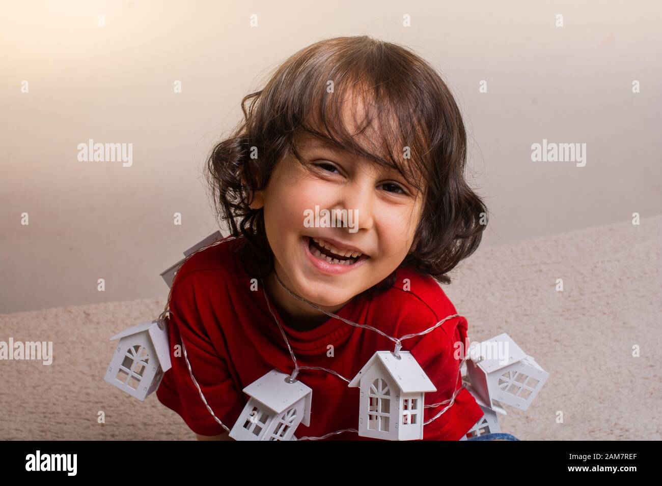 Small with house toys around his body as home concept Stock Photo - Alamy