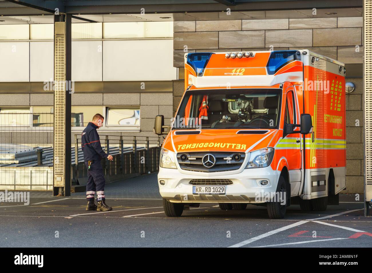 tired paramedic resting near an ambulance after hospitalizing patient ...