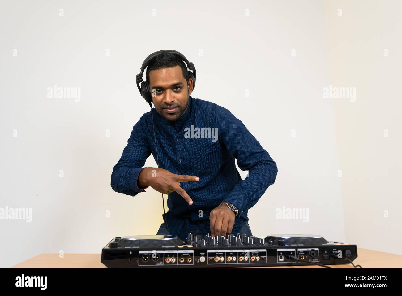 Male DJ playing music on white background Stock Photo - Alamy
