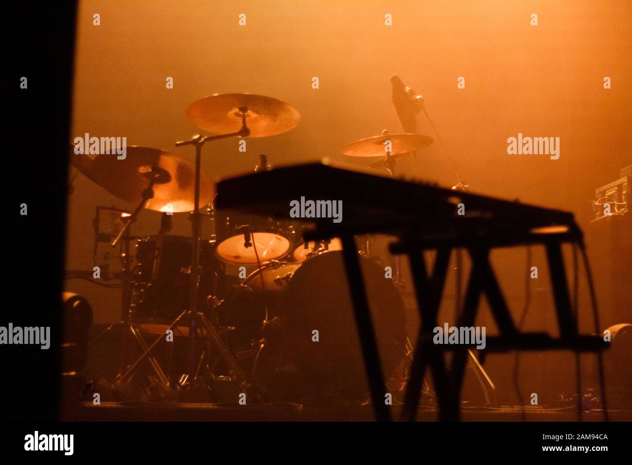 Musical instruments on the stage filled with orange light Stock Photo ...