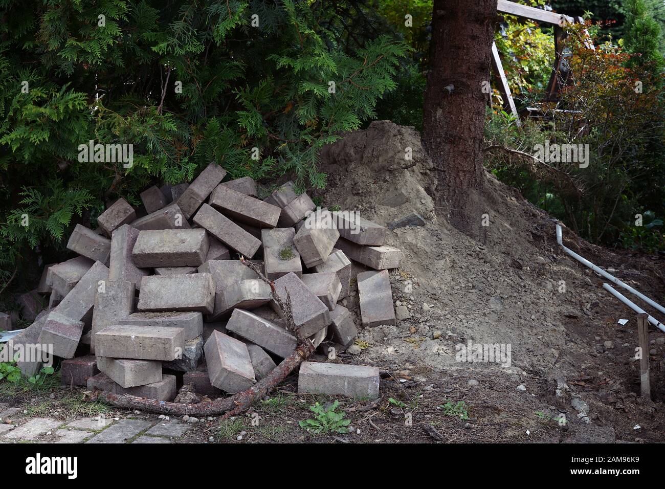 renovation in the garden - a pile of bricks Stock Photo - Alamy