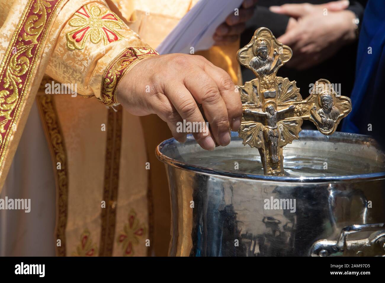 Adelaide, Australia. 12 January 2020.A Greek Orthodox clergy dips a ...