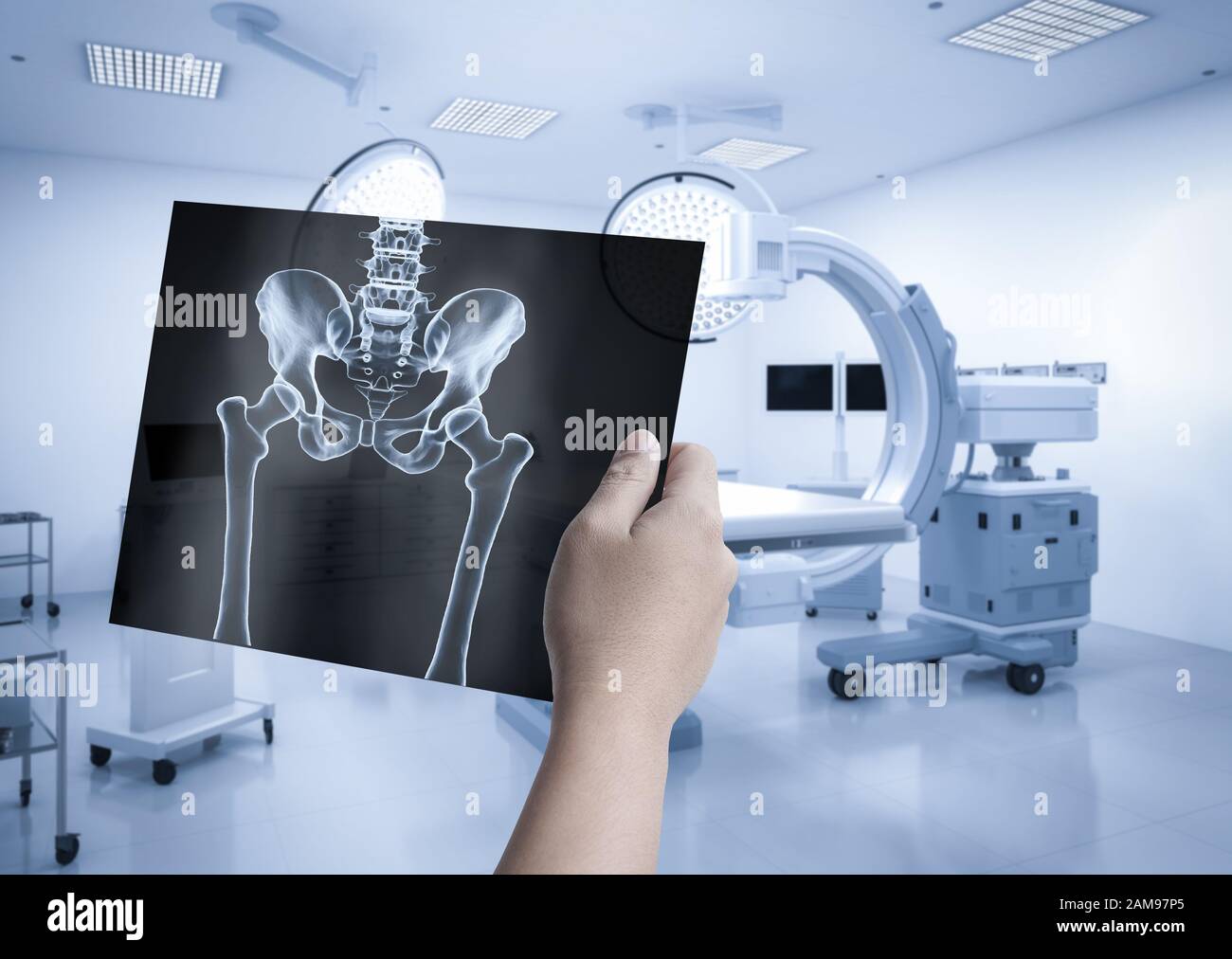 Hand holding x-ray film with 3d rendering mri scan machine or magnetic ...