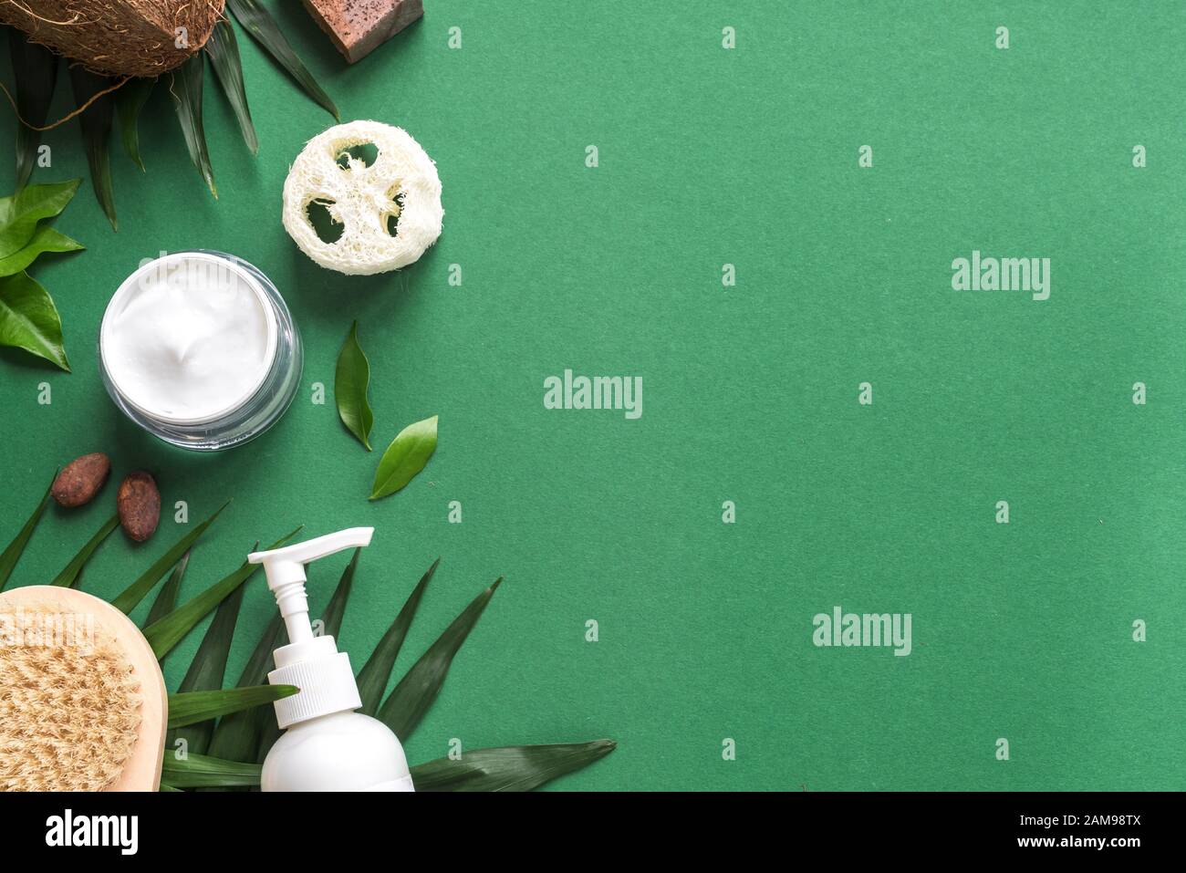 Organic Body Skin Care products with green leaves and coconut on green ...