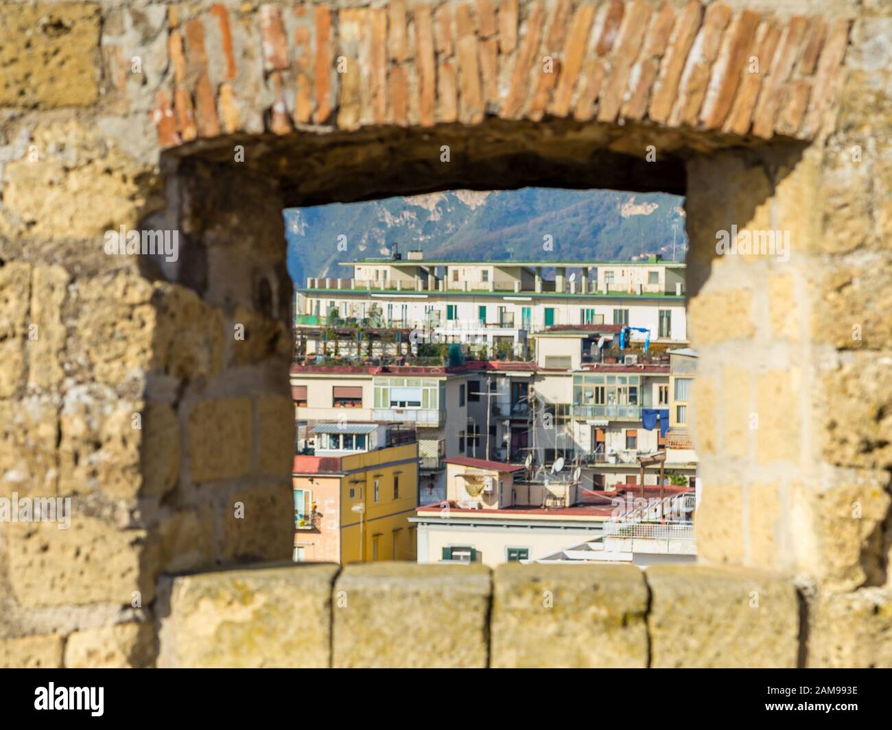 amazing view of the roofs of Napoli, Italy trough medieval rock window ...