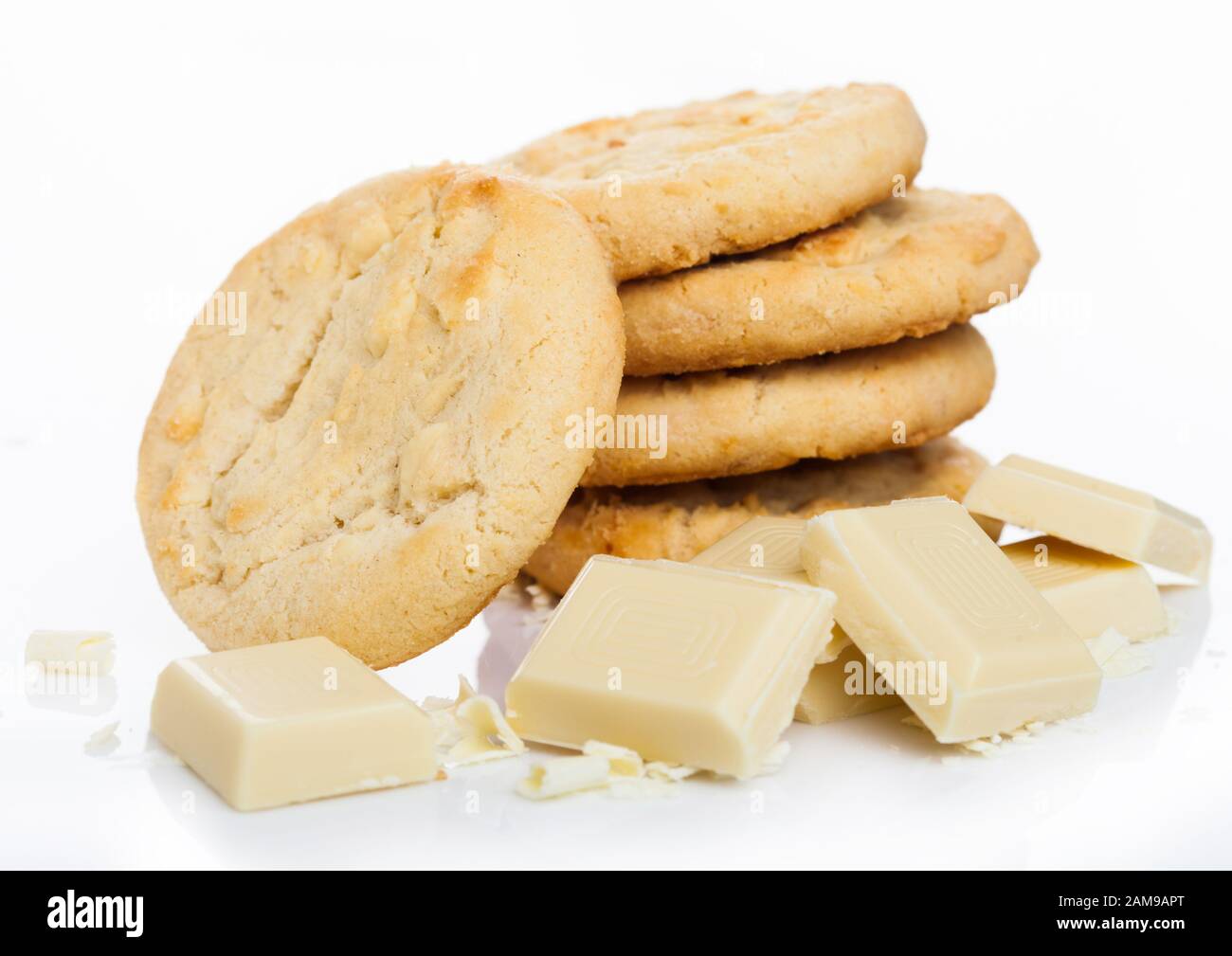 White chocolate biscuit cookies with chocolate blocks and curls on ...