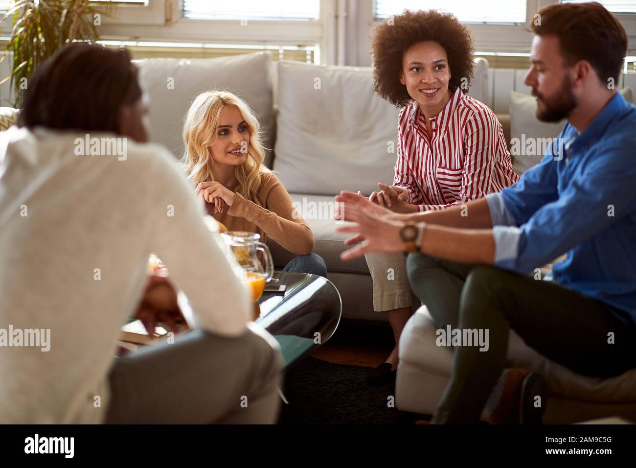 Young group of people in room talks Stock Photo - Alamy