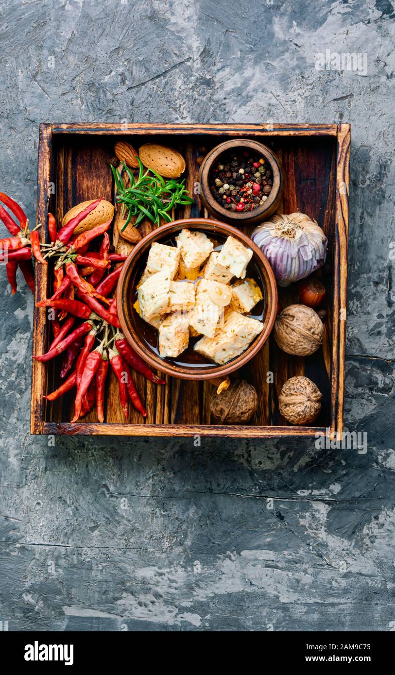 Feta cheese with herbs and garlic in bowl Stock Photo - Alamy