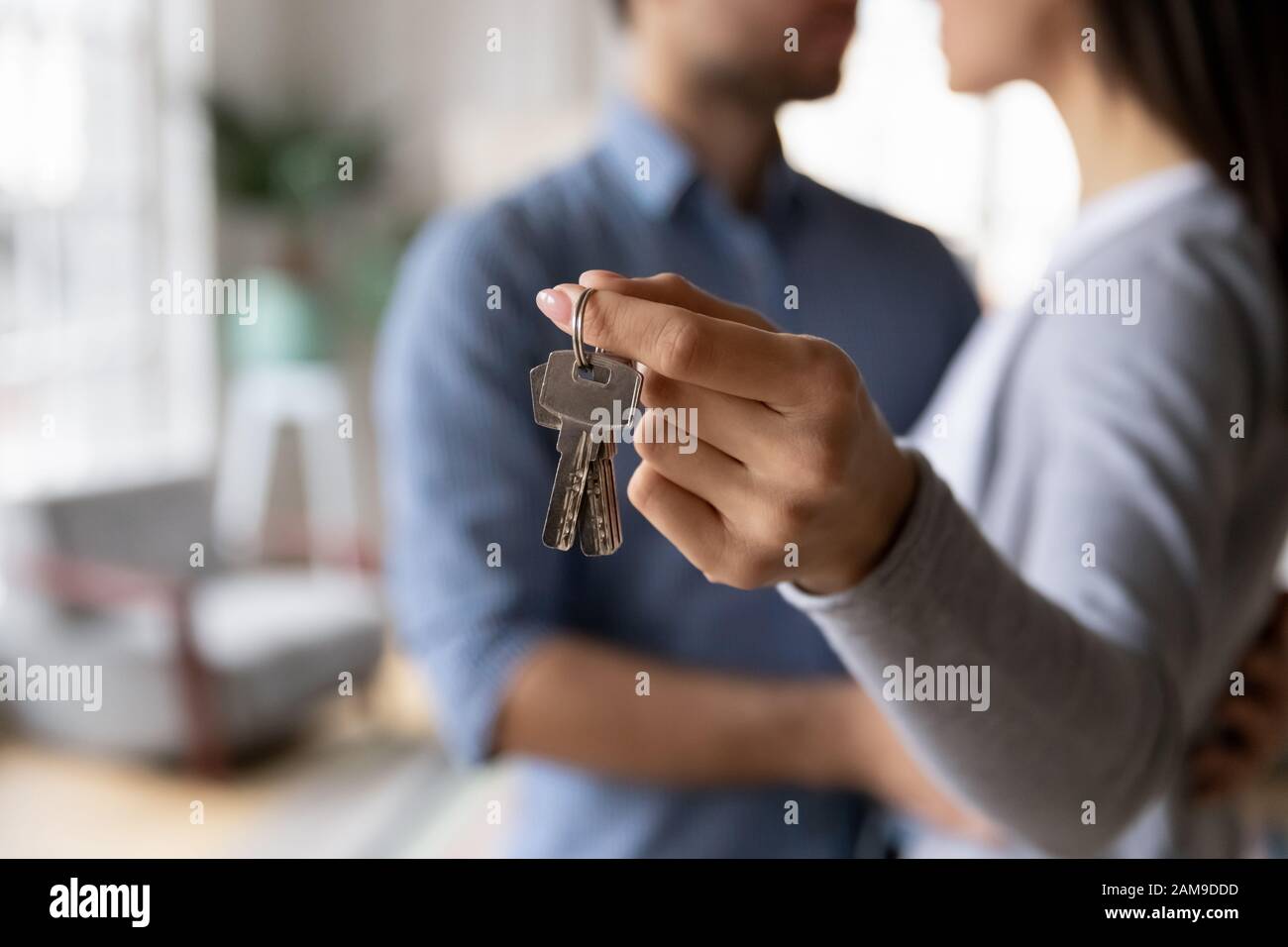 Young couple hug show house keys moving together Stock Photo - Alamy