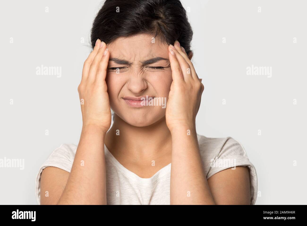 Stressed nervous unhealthy young indian woman suffering from head ache ...