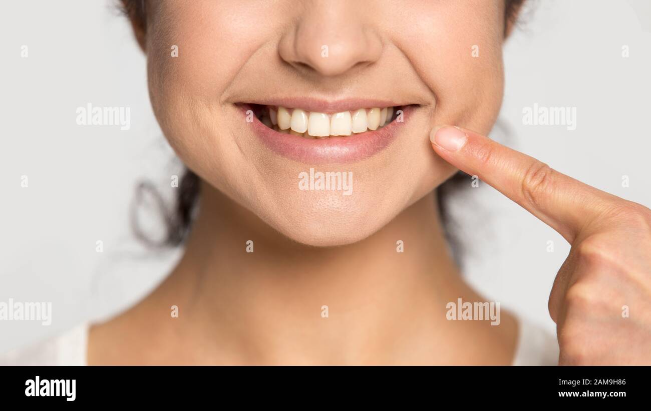 Close up happy smiling indian woman pointing finger at smile Stock ...