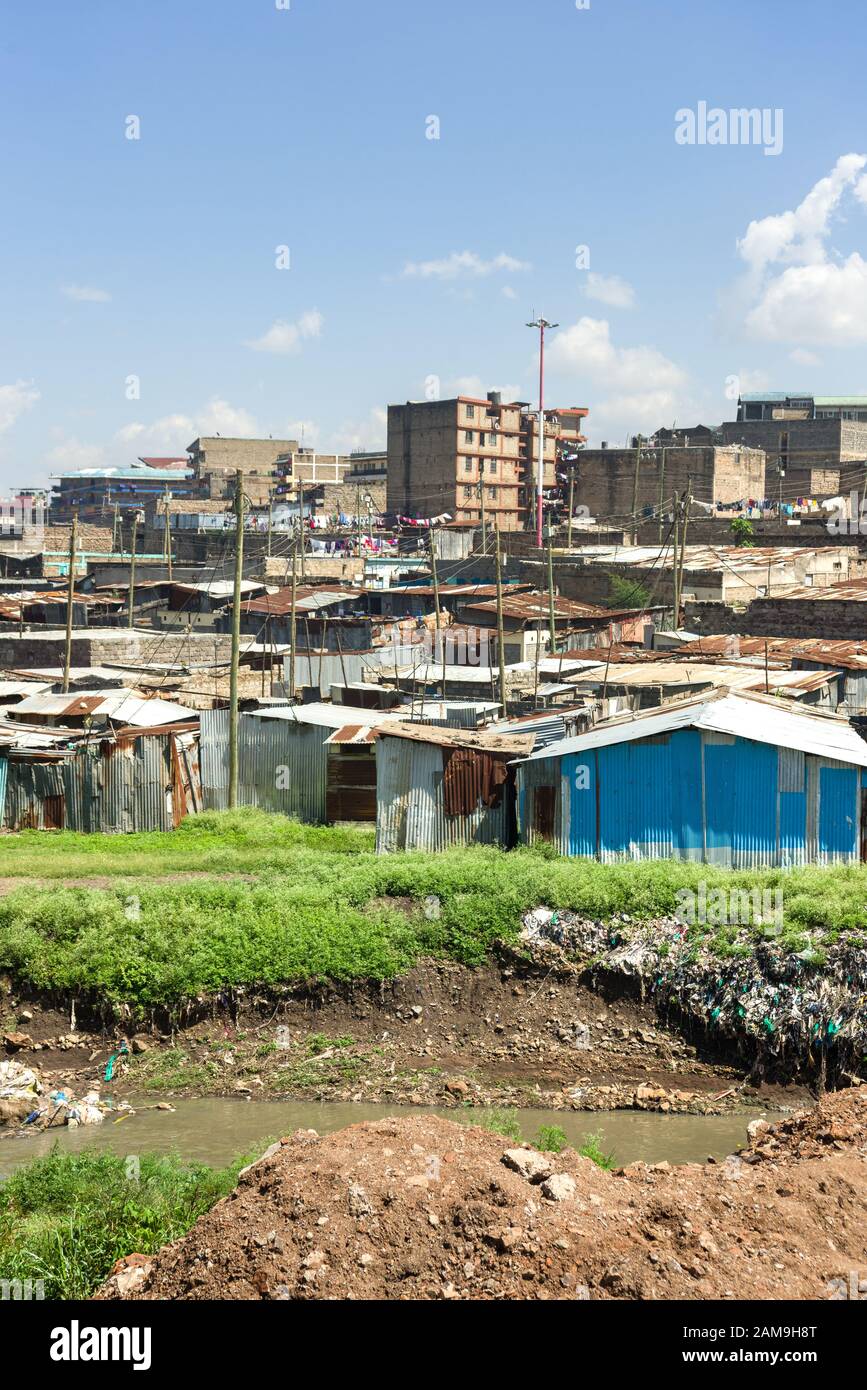 View of Nairobi river, Korogocho slum shacks and other buildings ...