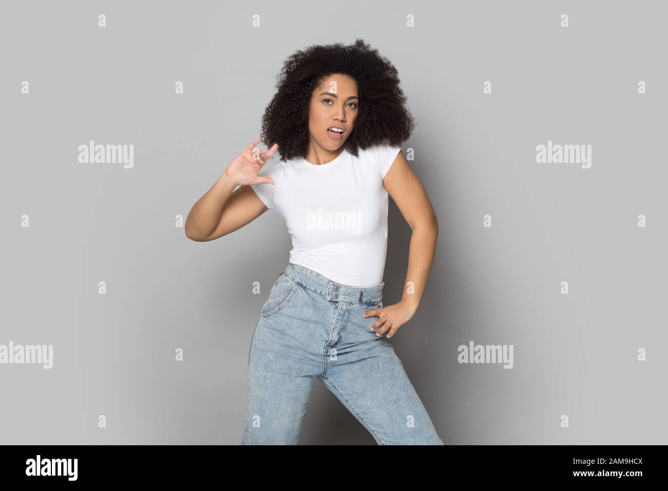 Happy african american millennial girl making stylish dancing pose ...