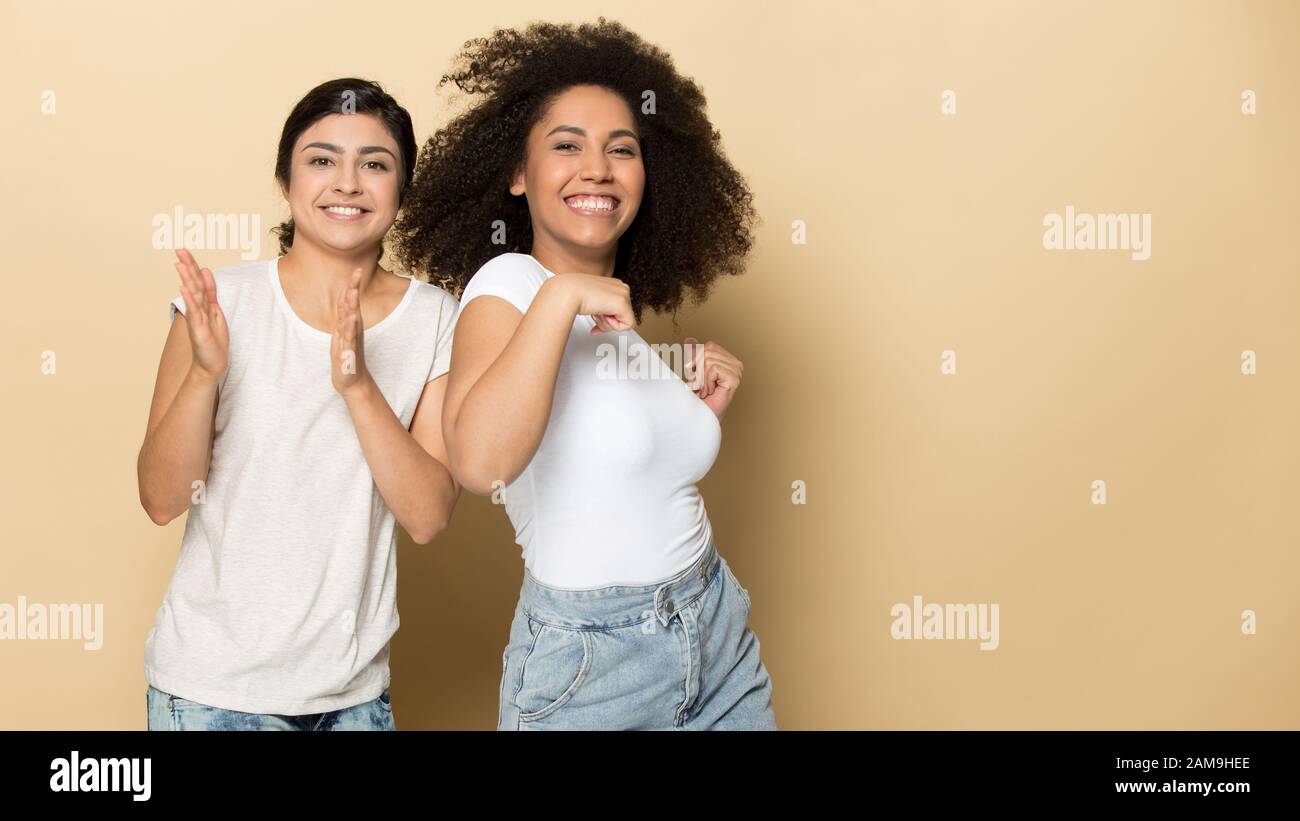 Joyful diverse multicultural female friends dancing together Stock ...