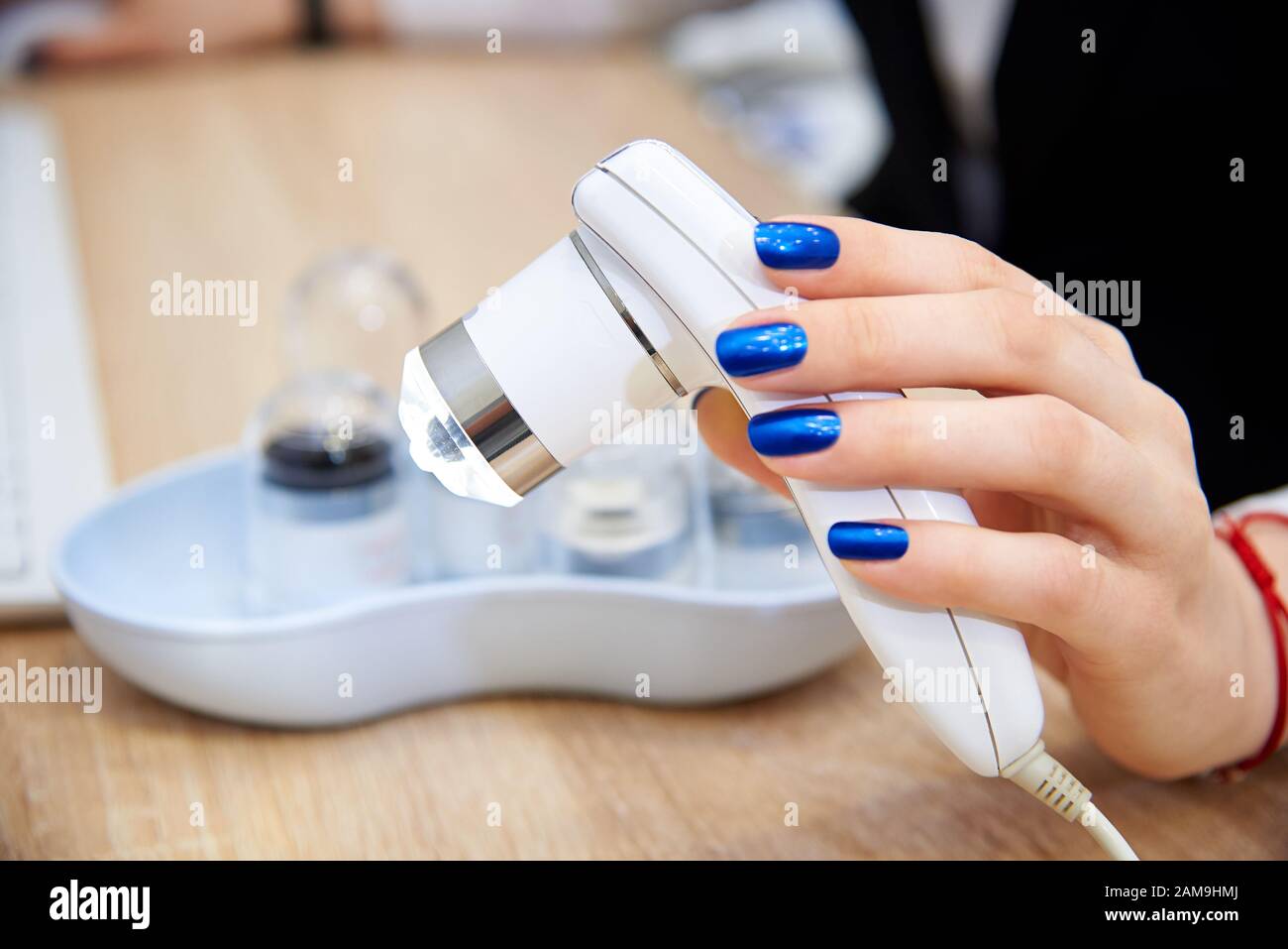 Trichoscope in a female hand. Device for the diagnosis of hair and ...