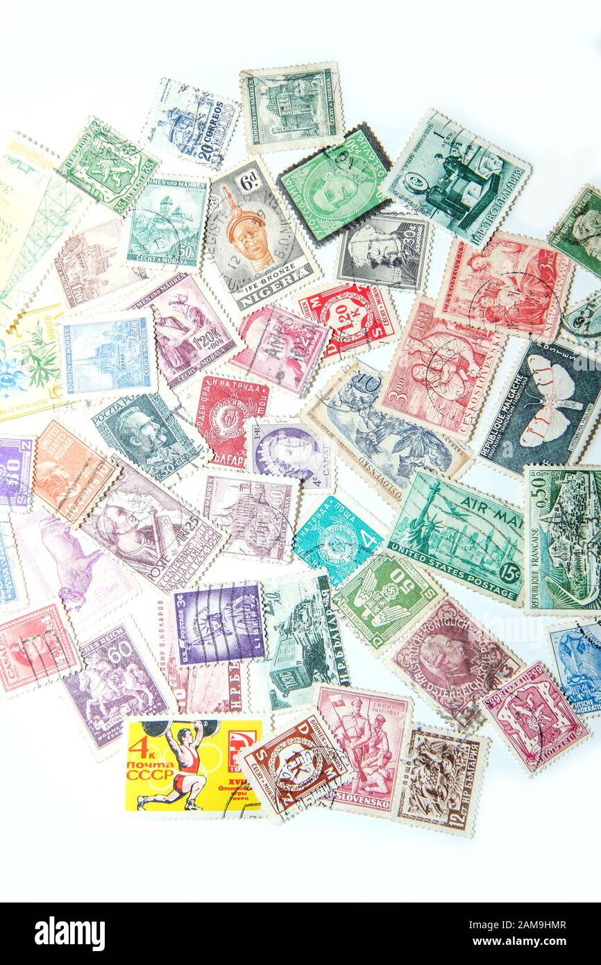 An assorted mixture of the old european and world stamps is lying on ...