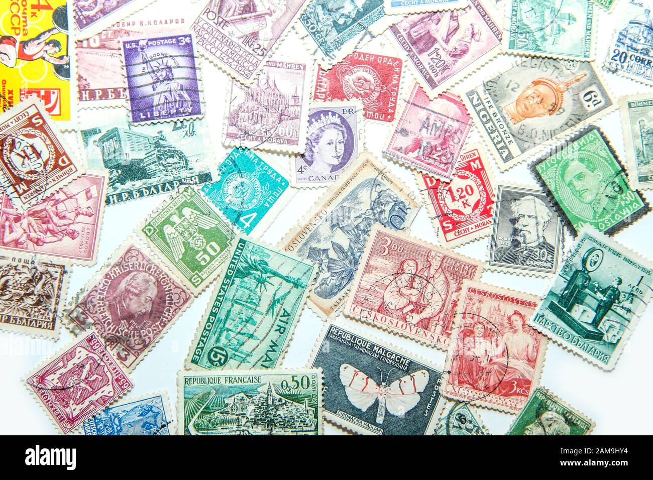 An assorted mixture of the old european and world stamps is lying on ...