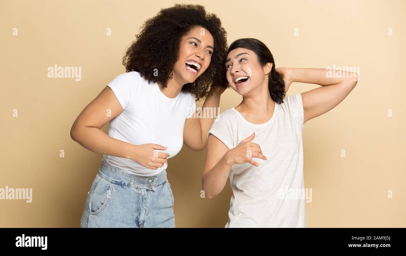 Studio picture overjoyed multicultural college friends having fun ...