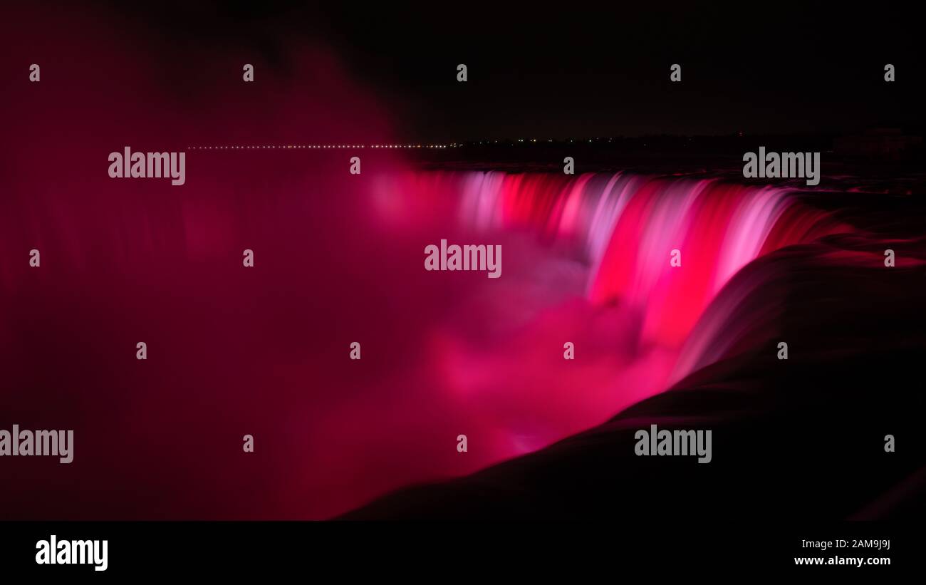 Niagara Falls is illuminated in glowing red colours Stock Photo - Alamy
