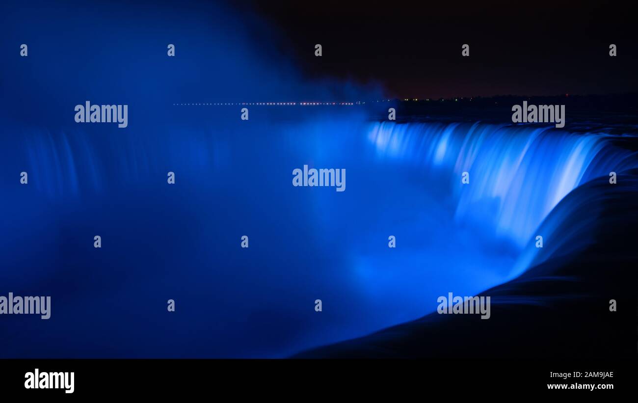 Niagara Falls illuminated in glowing blue colours Stock Photo - Alamy