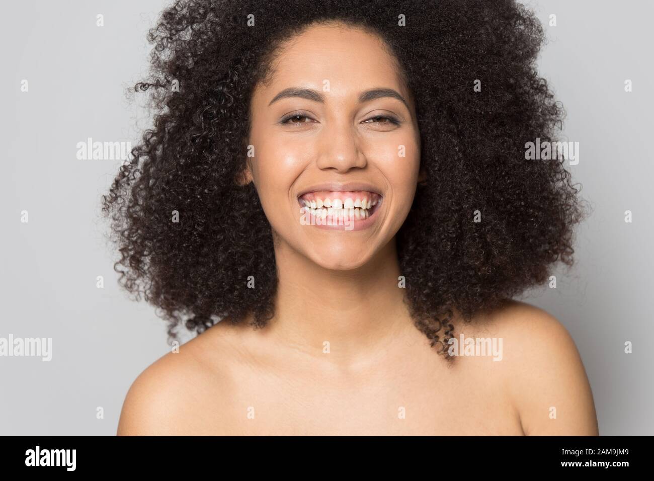 Smiling young female client satisfied with professional skin care ...