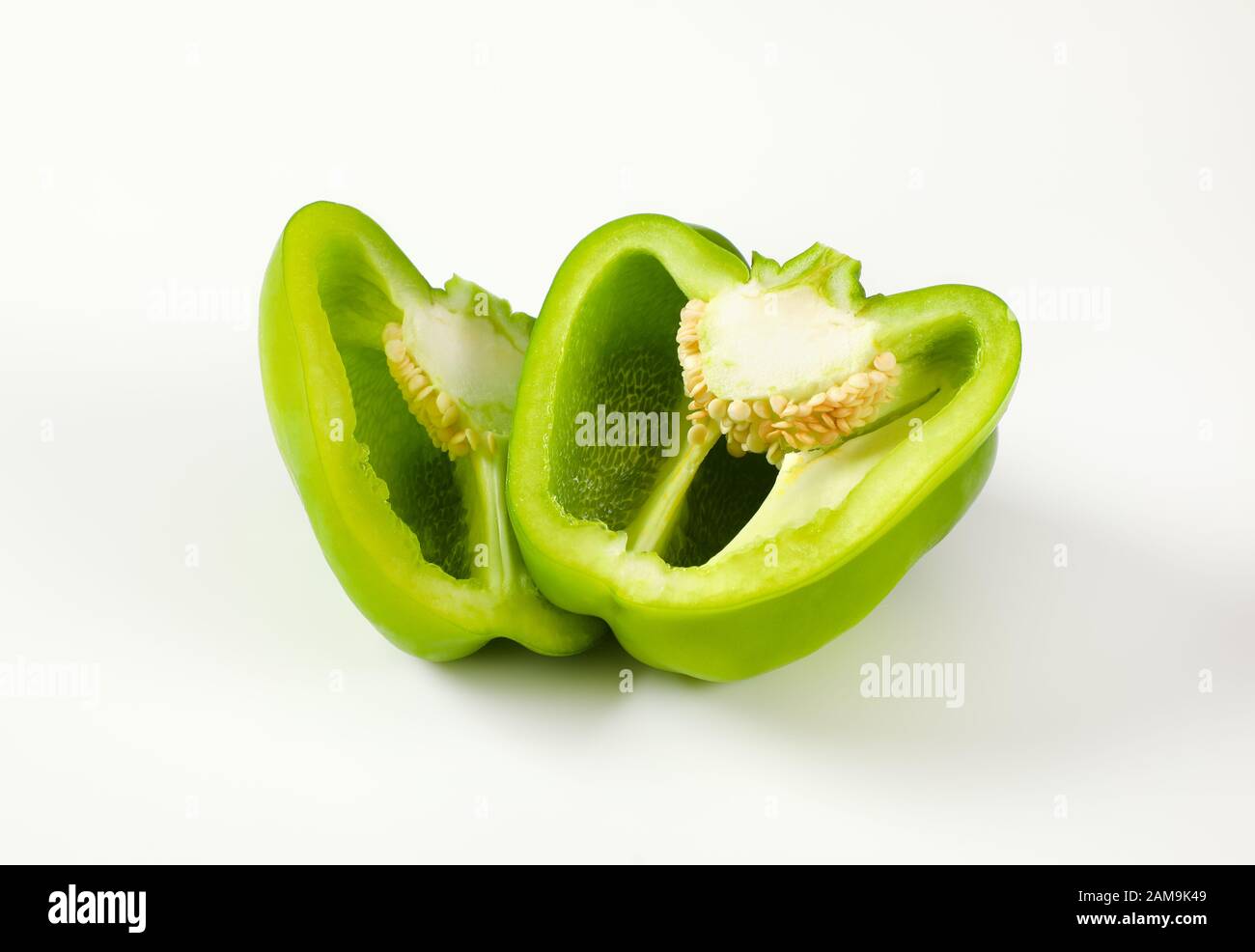 Halved raw green bell pepper Stock Photo - Alamy