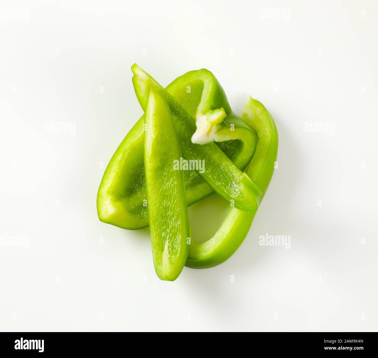 Green bell pepper cut into pieces Stock Photo - Alamy