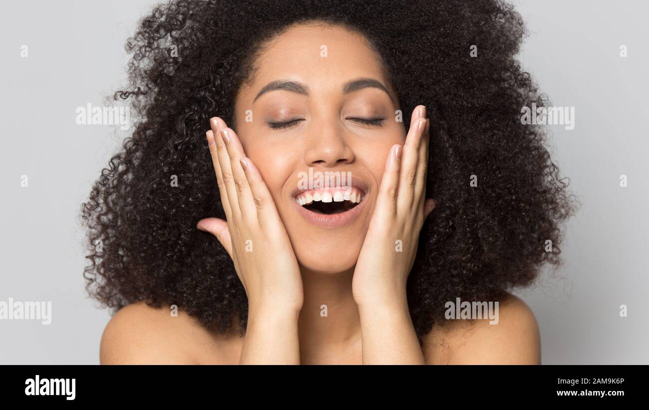 Smiling african american woman touching smooth cheeks Stock Photo - Alamy